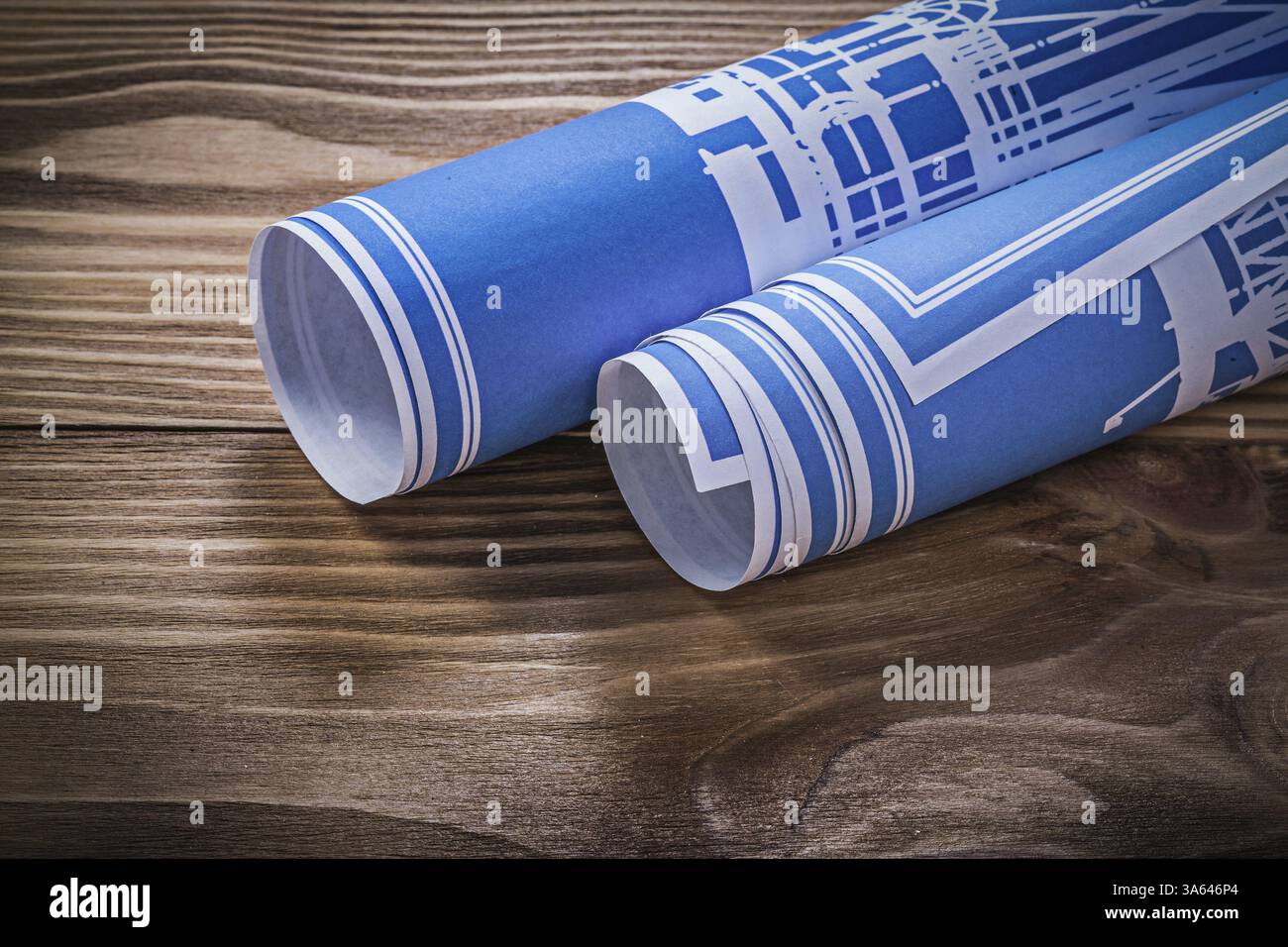 Blue engineering drawings on vintage wooden board construction concept ...