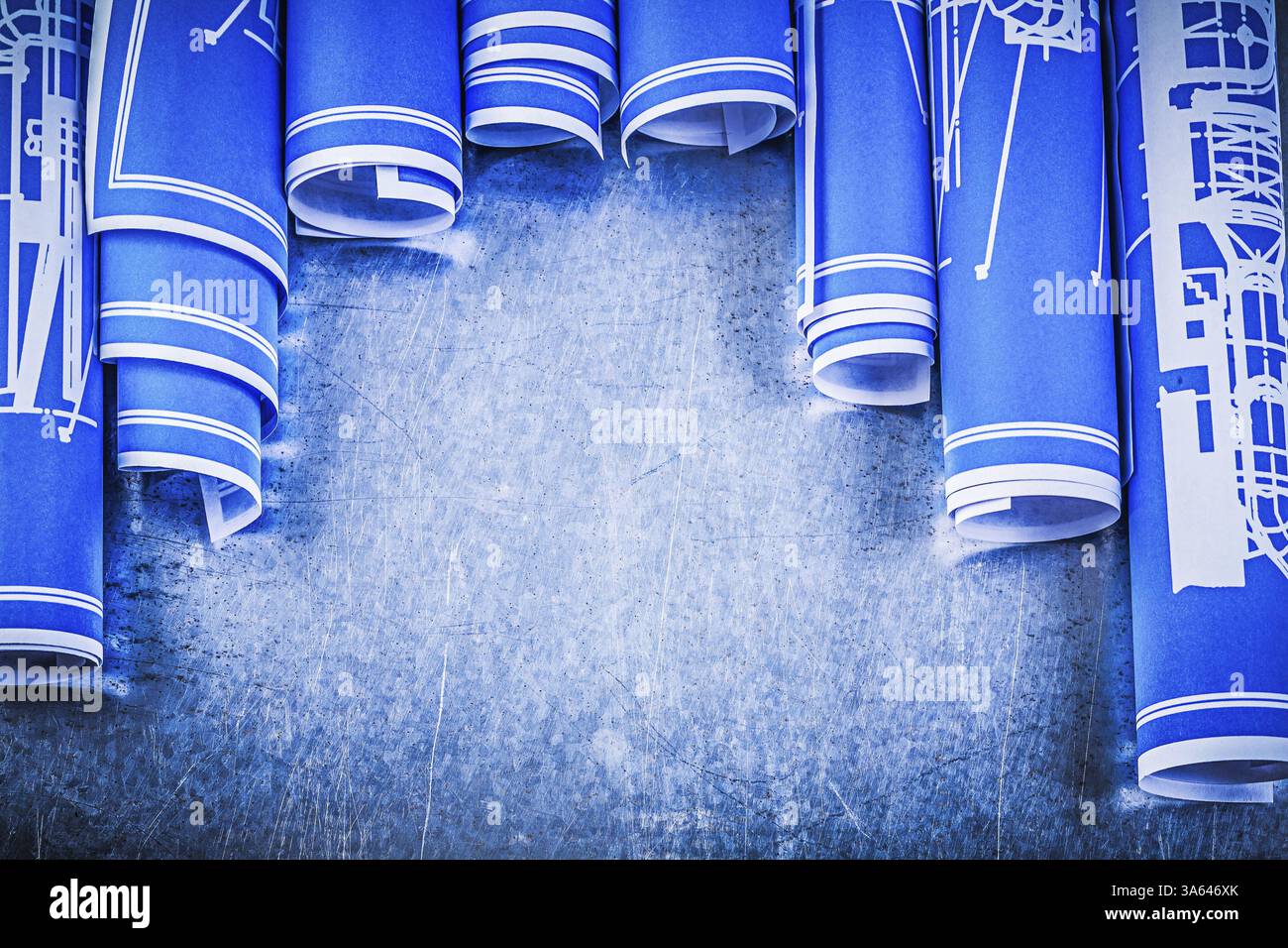 Blue rolled engineering drawings on metallic background construction ...