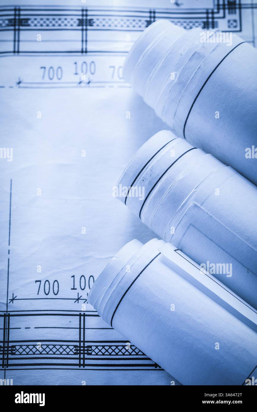 Rolled up construction drawings on blueprint top view Stock Photo - Alamy