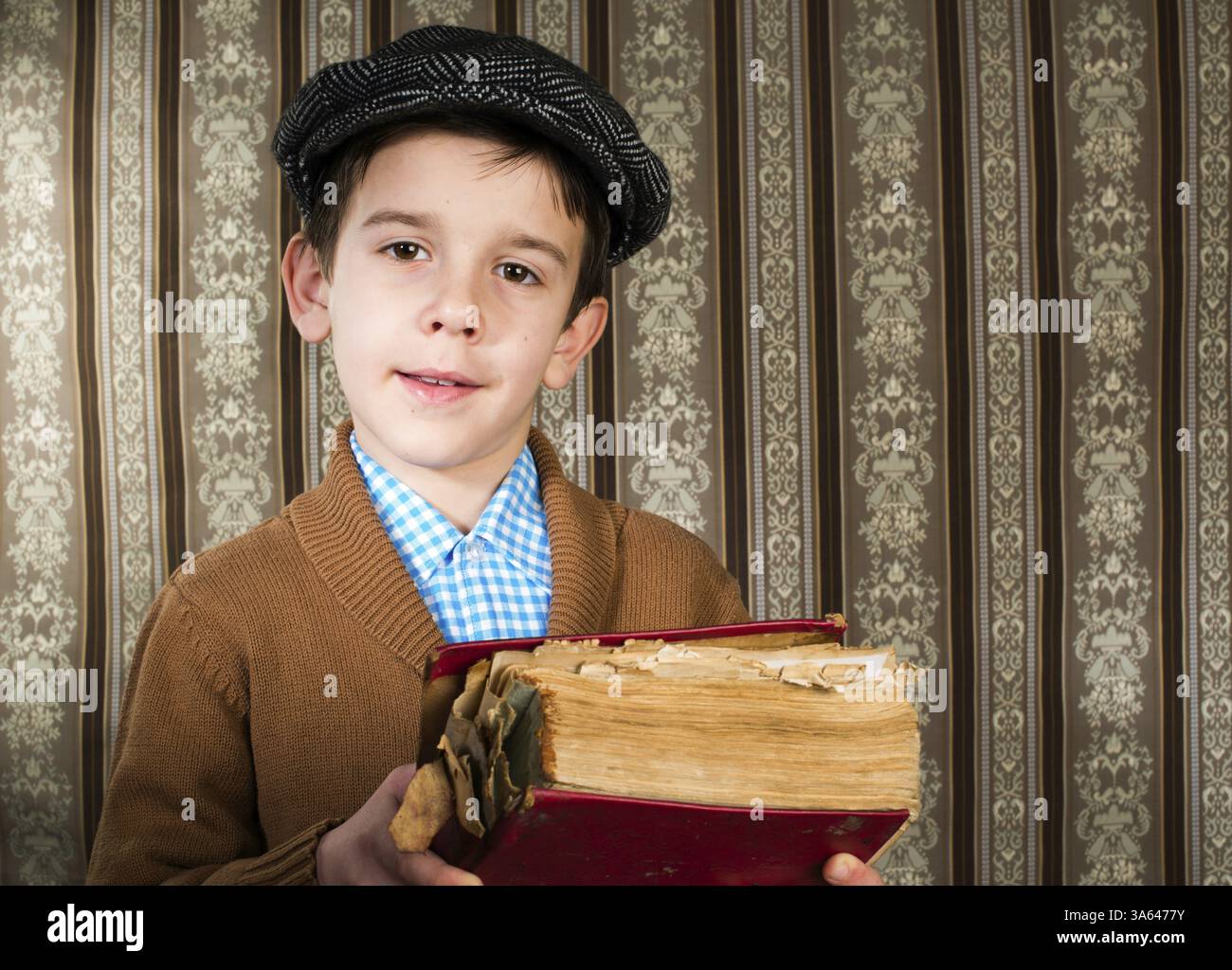 Child with red vintage book. Vintage clothes and hat Stock Photo - Alamy
