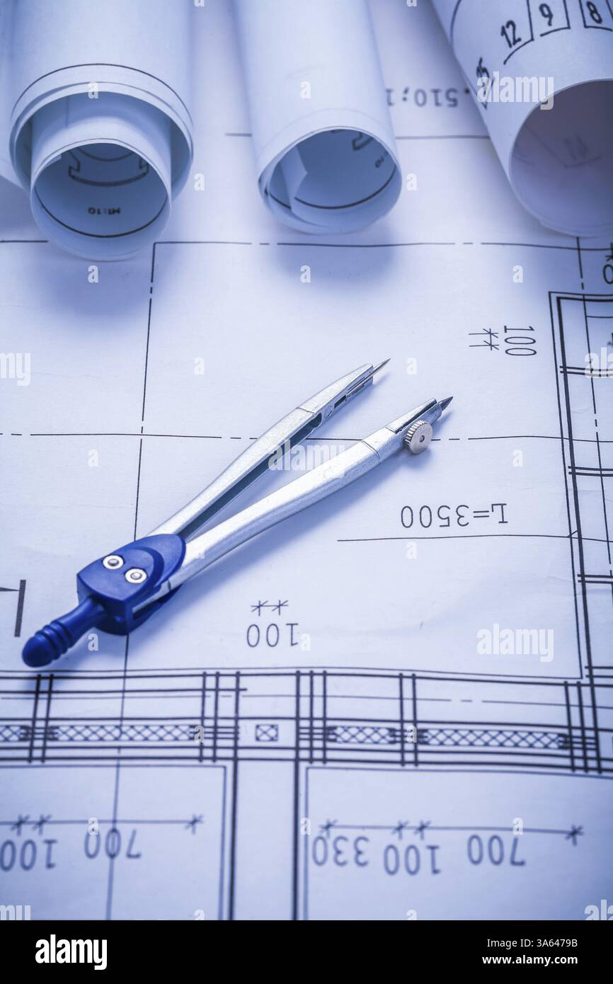 Compass and rolled blueprints close up Stock Photo - Alamy