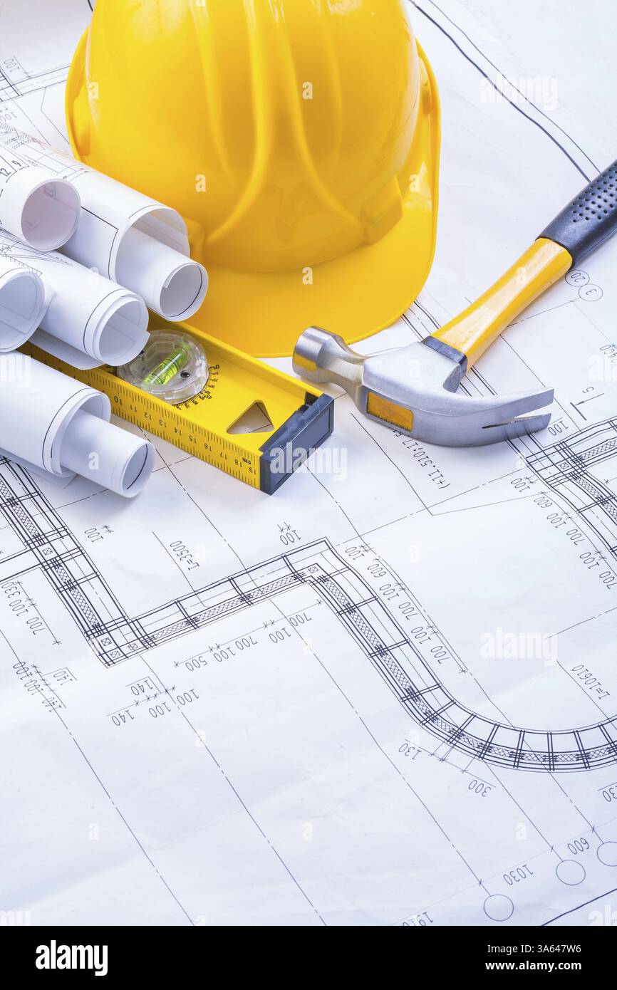 Claw hammer rolled blueprints construction level helmet Stock Photo - Alamy
