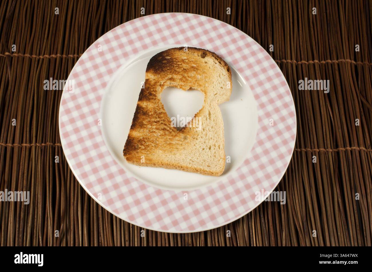 Toast with heart-shaped set in white plate Stock Photo - Alamy