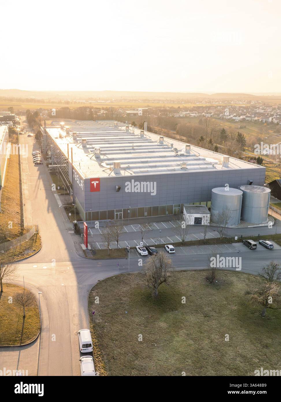 Large industrial building from above, surrounded by streets and parked ...