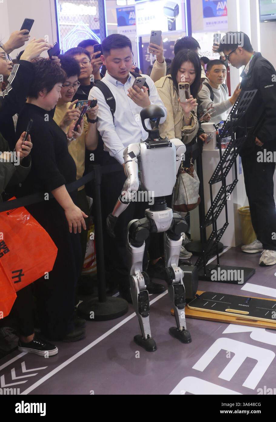 SHANGHAI, CHINA - MARCH 20, 2025 - Visitors visit UNITREE G1 humanoid robot and Go2 Quadruped ...