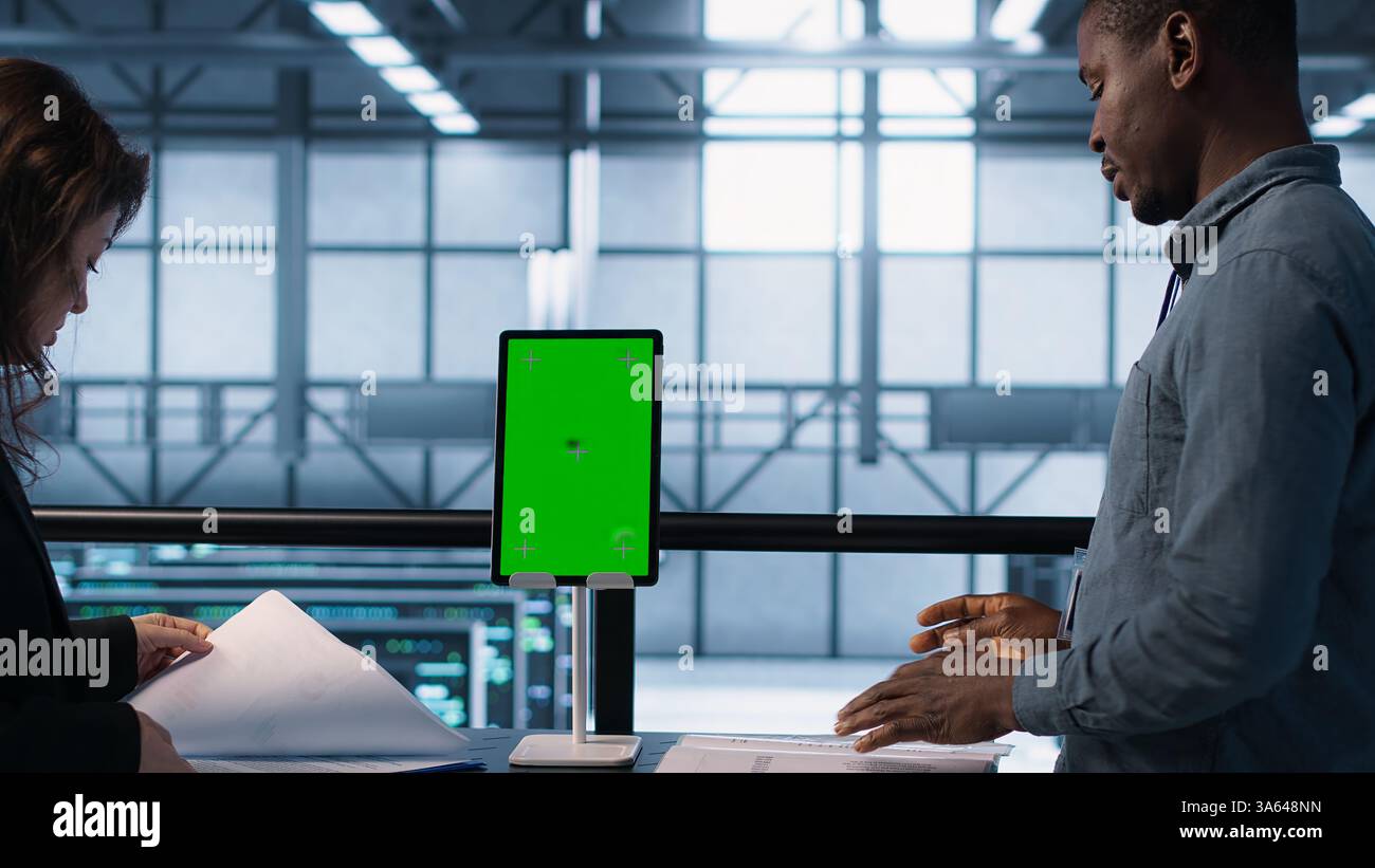 Inspector Checking Documents In Server Hub To Ensure Compliance With Industry Standards Using