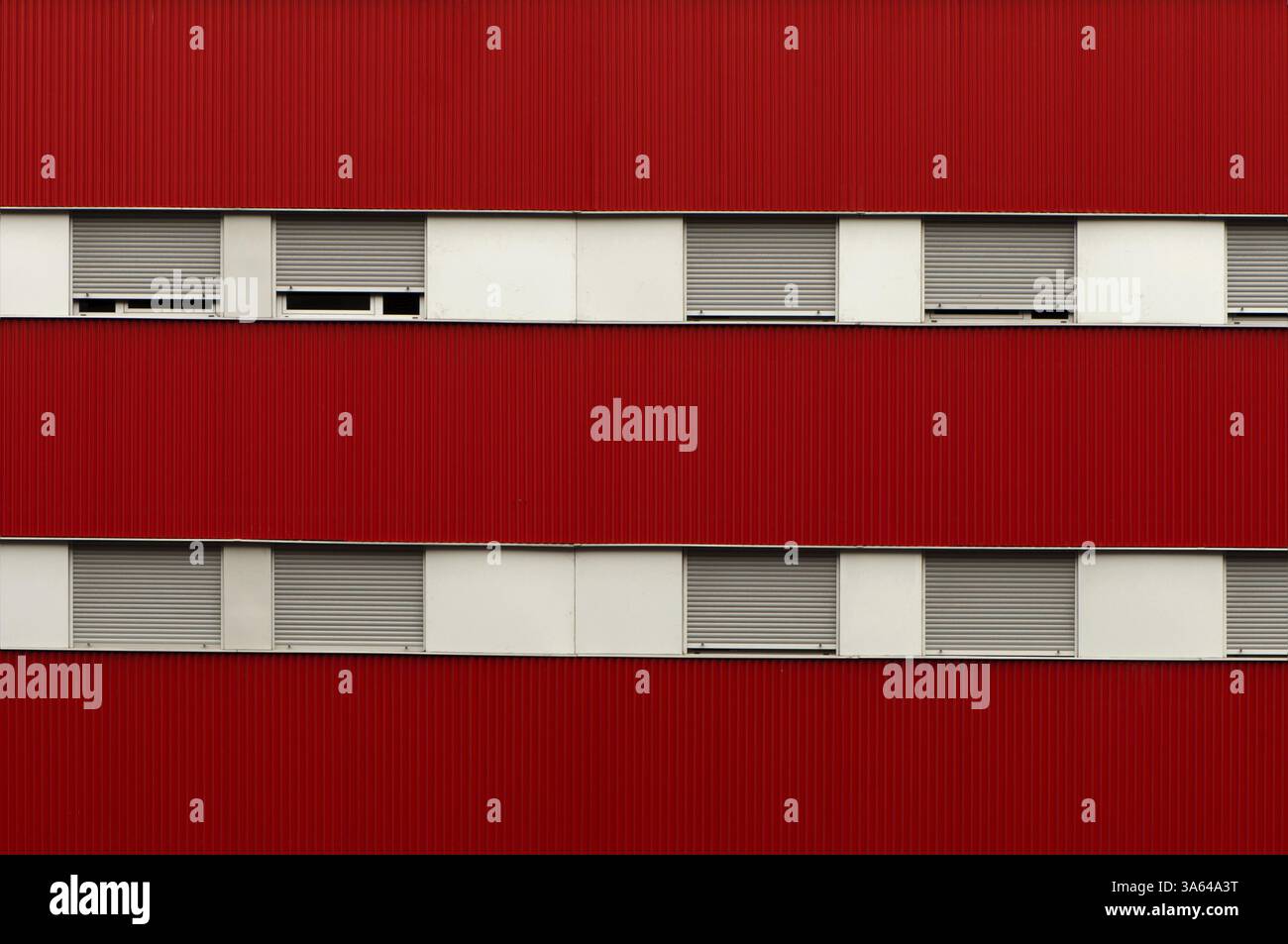 Red color facade and windows of a building Stock Photo - Alamy