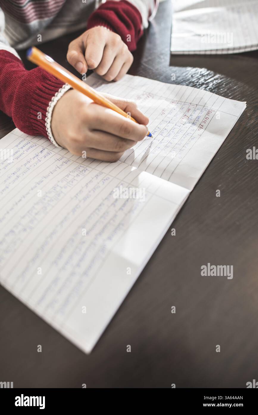 Child write in a notebook. Close up hand and pen Stock Photo - Alamy