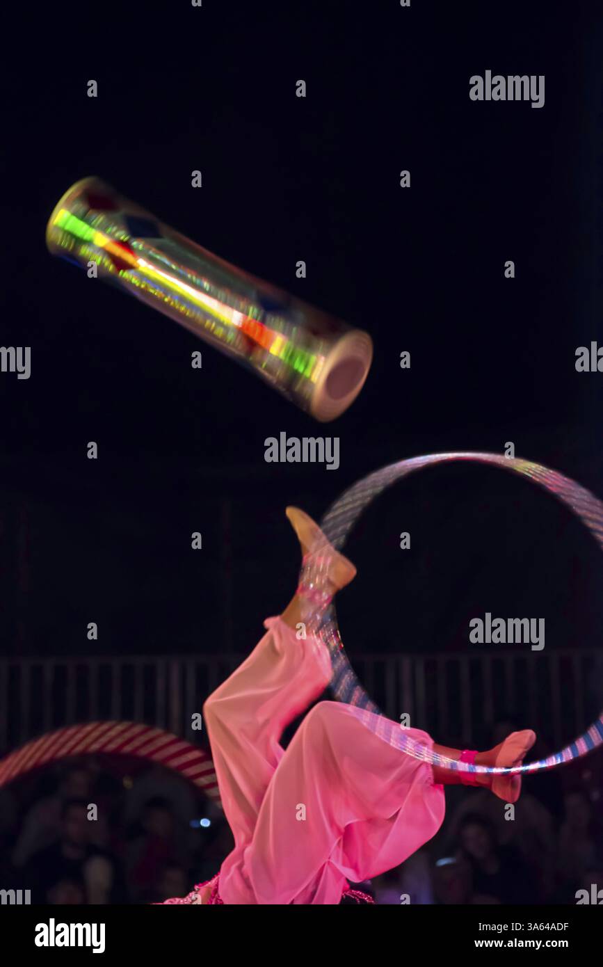 Juggler in the circus on black background Stock Photo - Alamy