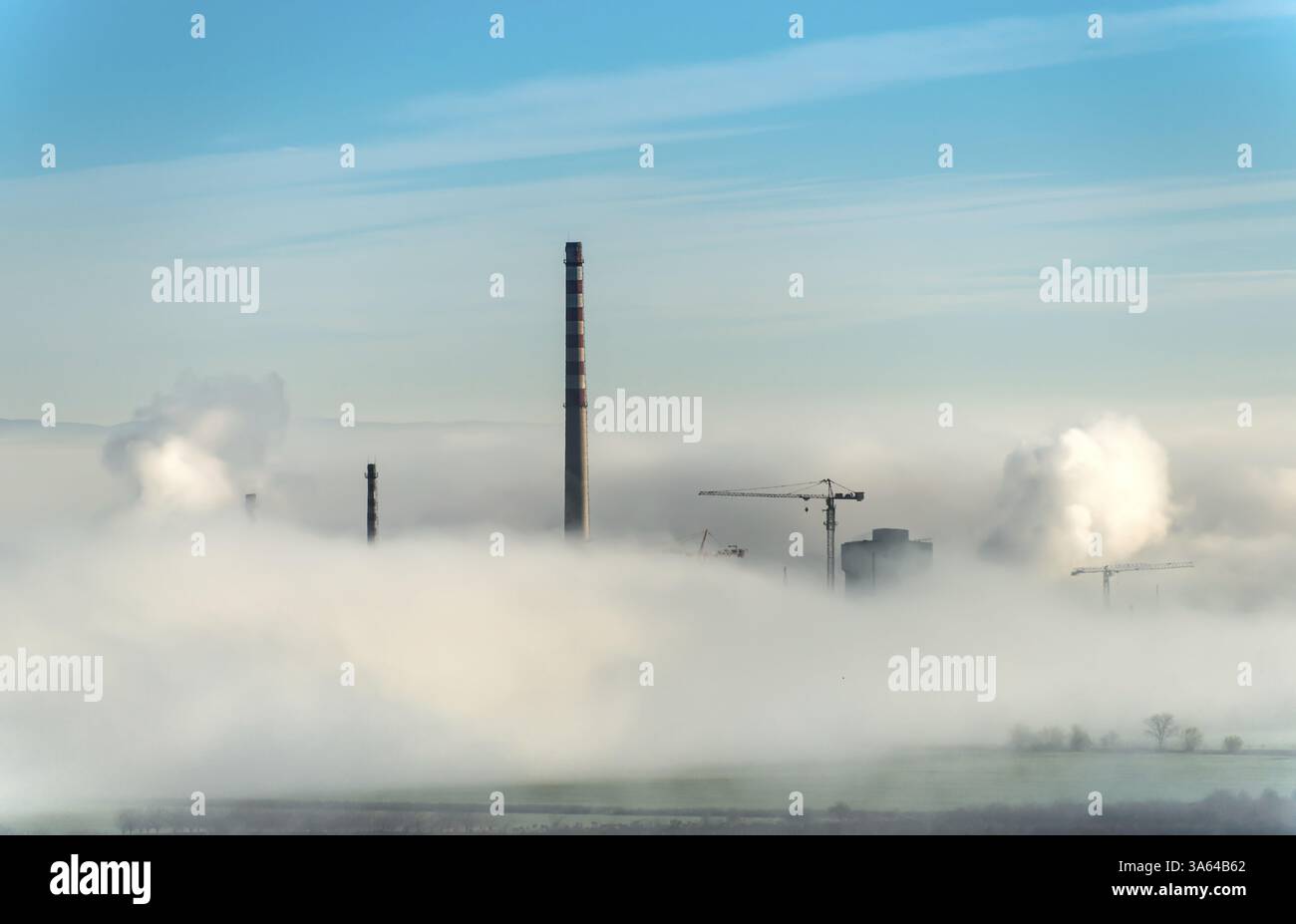Factory chimneys and clouds of steam.Blue sky Stock Photo - Alamy