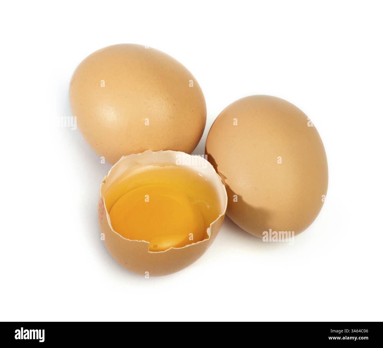 Tree whole eggs and another broken in half raw egg and yolk inside ...