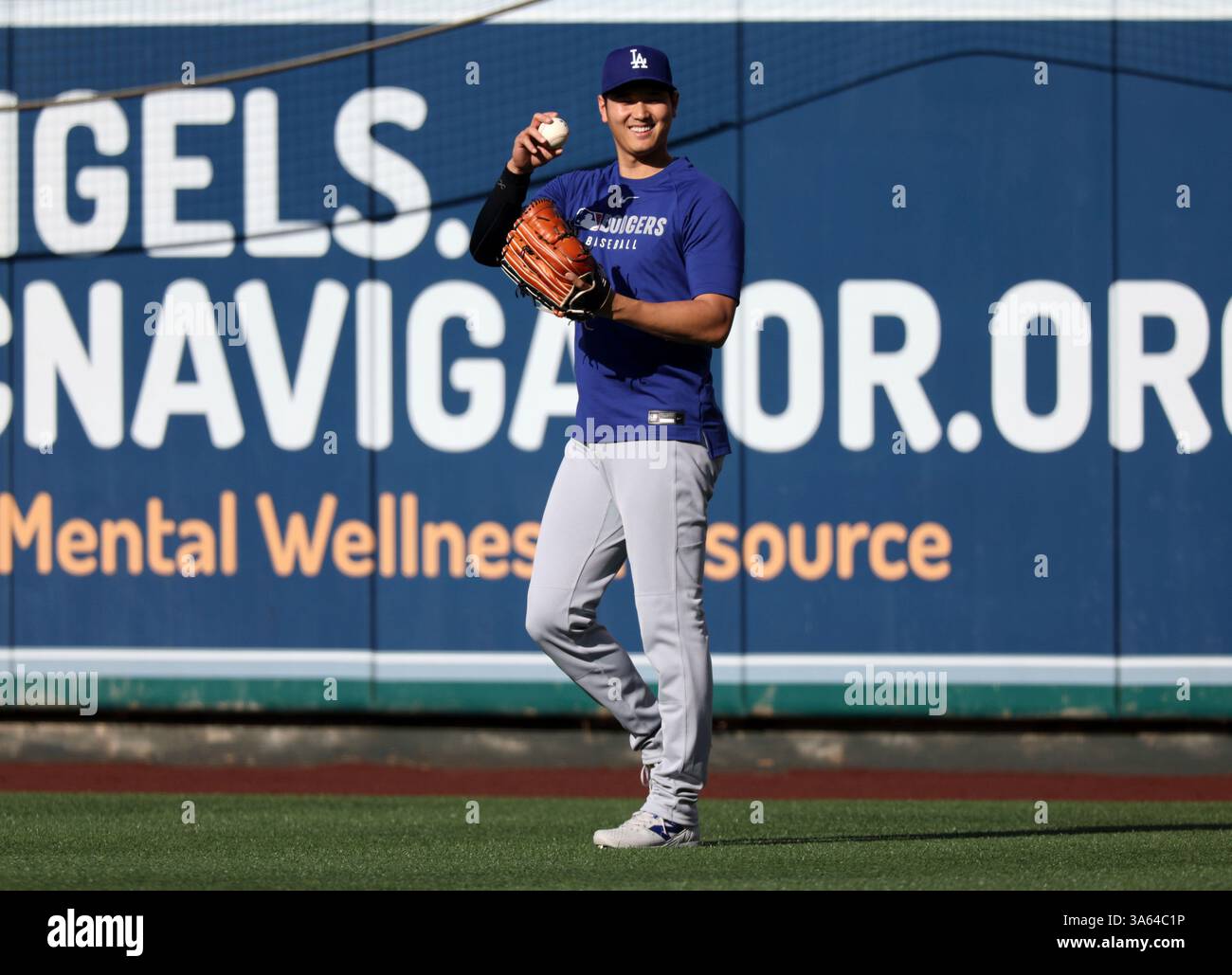 Los Angeles Dodgers' Shohei Ohtani throws in the outfield before a ...
