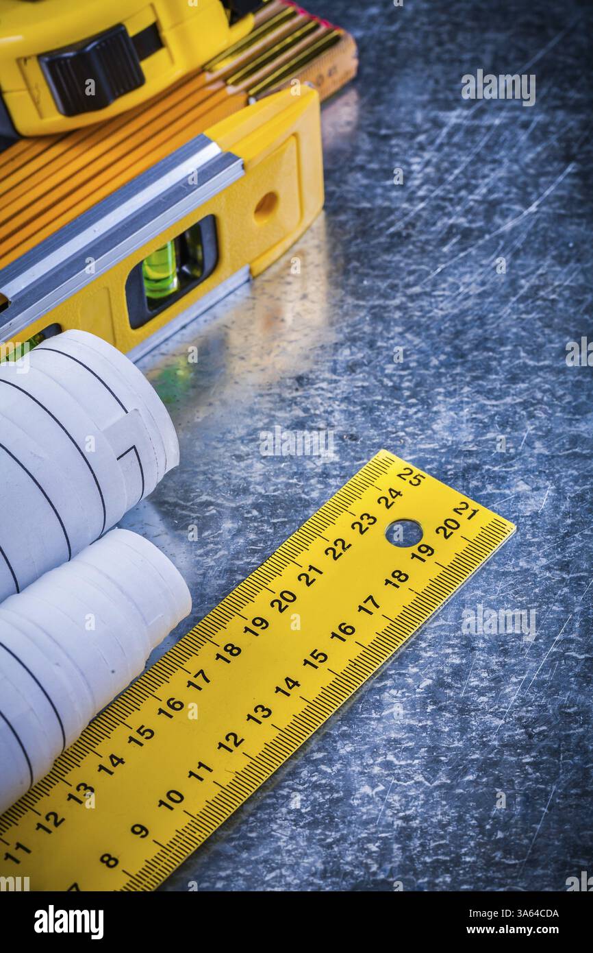 Construction level blueprints and units of measurement on metallic ...
