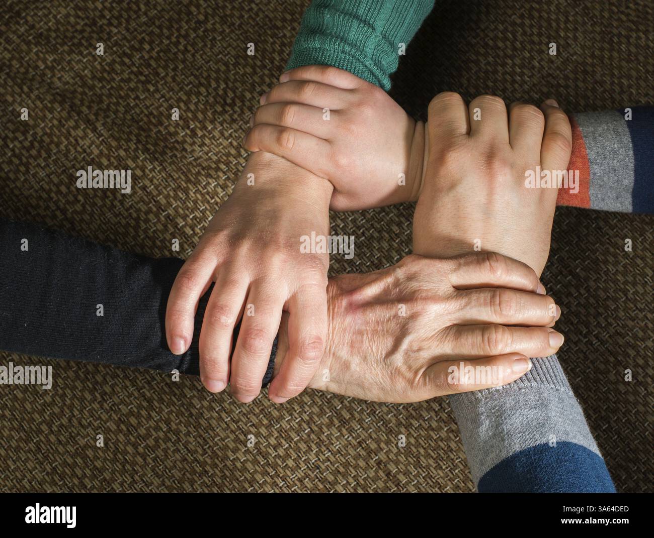 Many hands together. Interior shot Stock Photo - Alamy