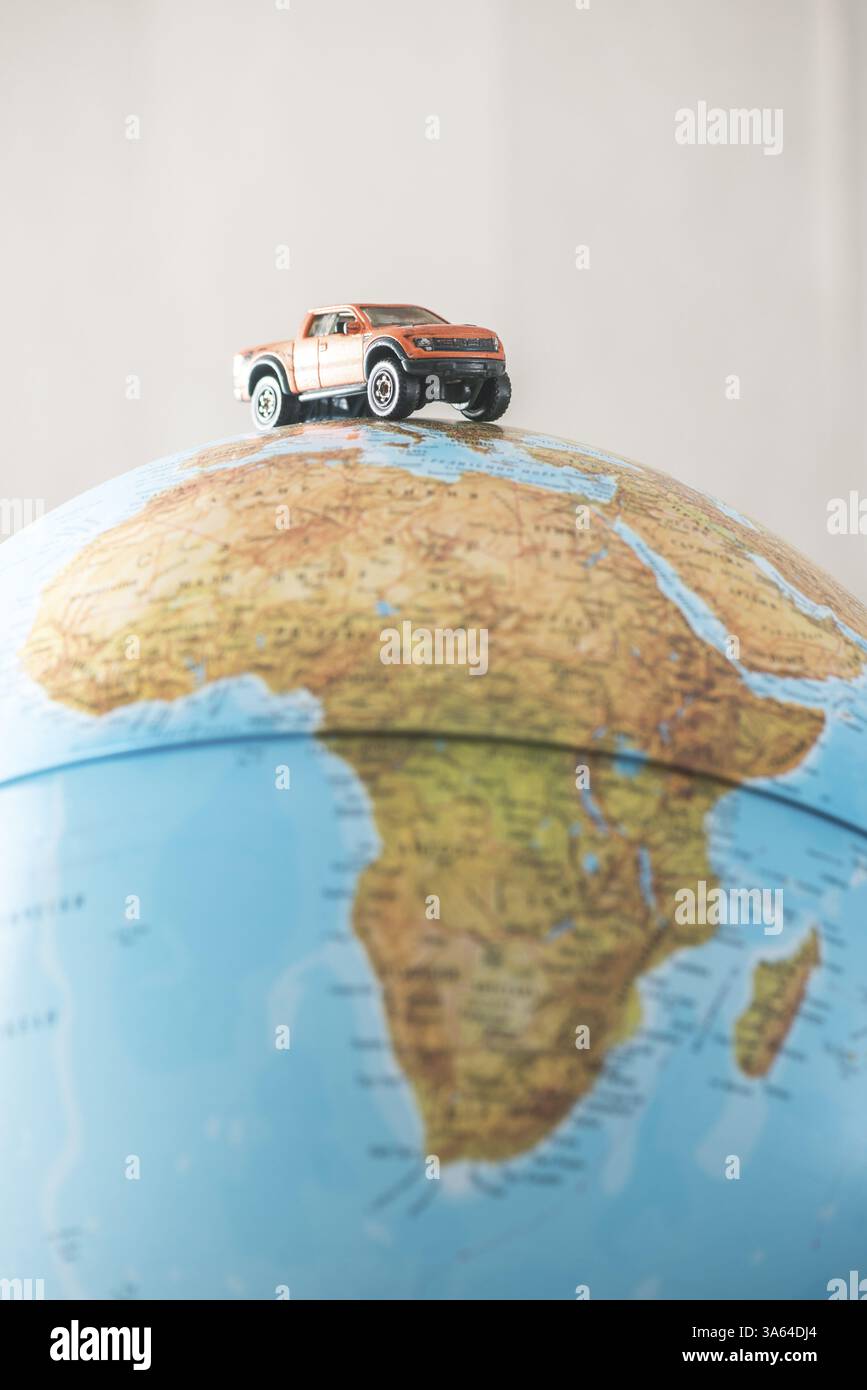 Offroad car on globe. Miniature concept Stock Photo - Alamy