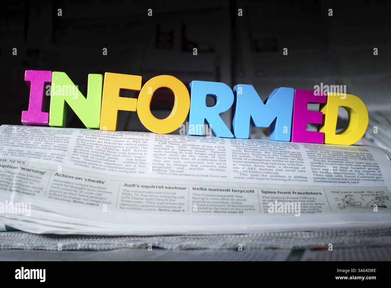 Word informed on newspaper. Wooden letters Stock Photo - Alamy