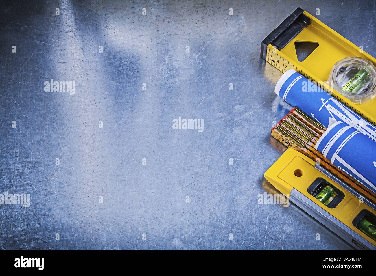 Blue blueprints levels wooden meter on metallic surface copy space ...