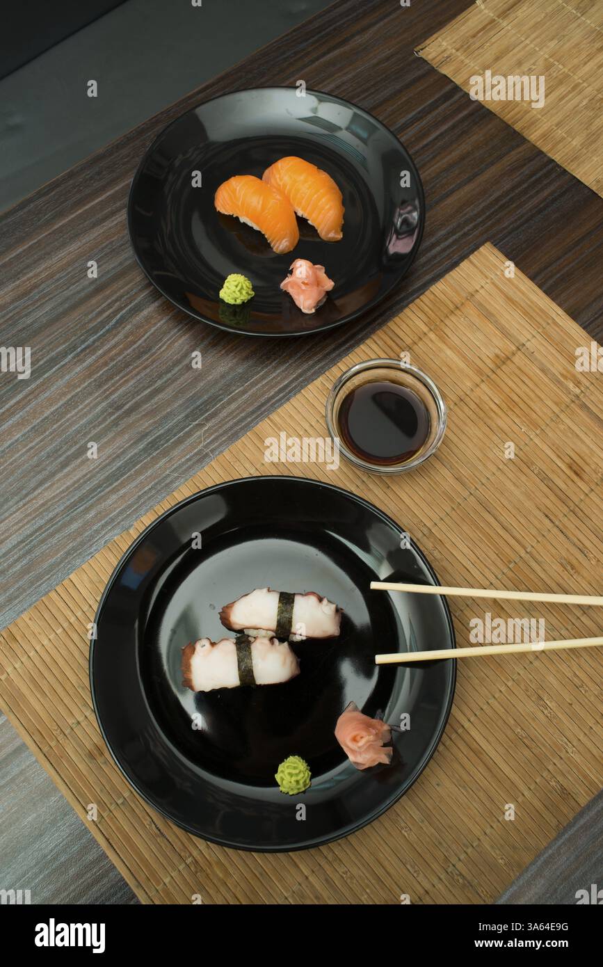 Sushi in sushi bar. Table and ration sushi Stock Photo - Alamy