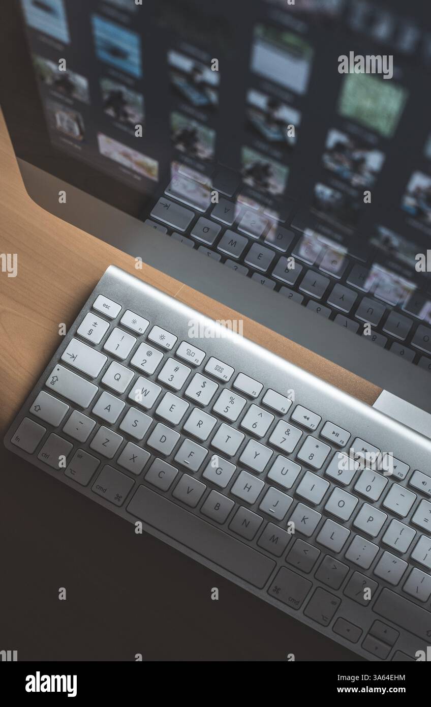 Many pictures on computer monitor. Keyboard Stock Photo - Alamy