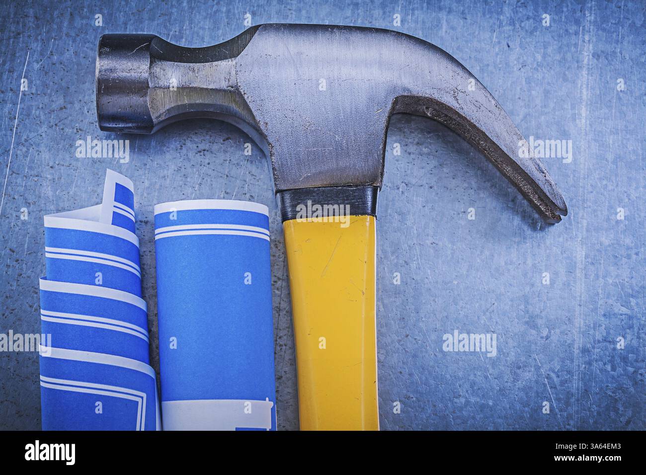 Composition of blue construction plans claw hammer on metallic ...