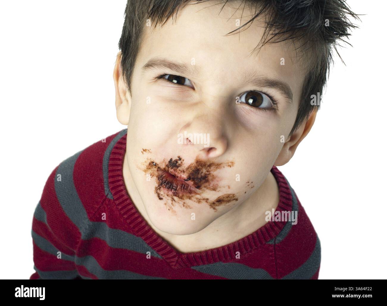 Smiling kid eating chocolate. Smeared stained with chocolate lips ...