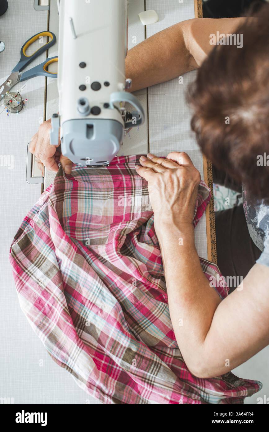 Women sew on sewing machine. White machine Stock Photo - Alamy