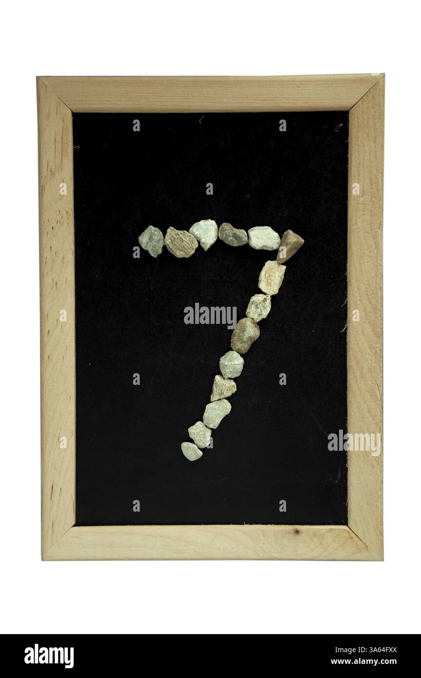 Number seven stone made on black background in frame Stock Photo - Alamy