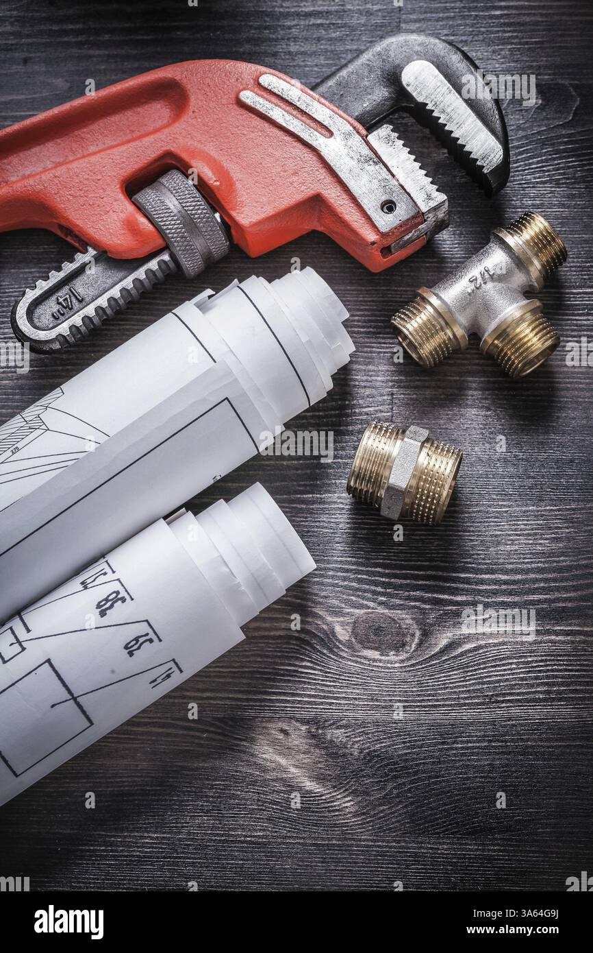 Pipe wrench copper plumbing fixtures rolled up construction plans Stock ...