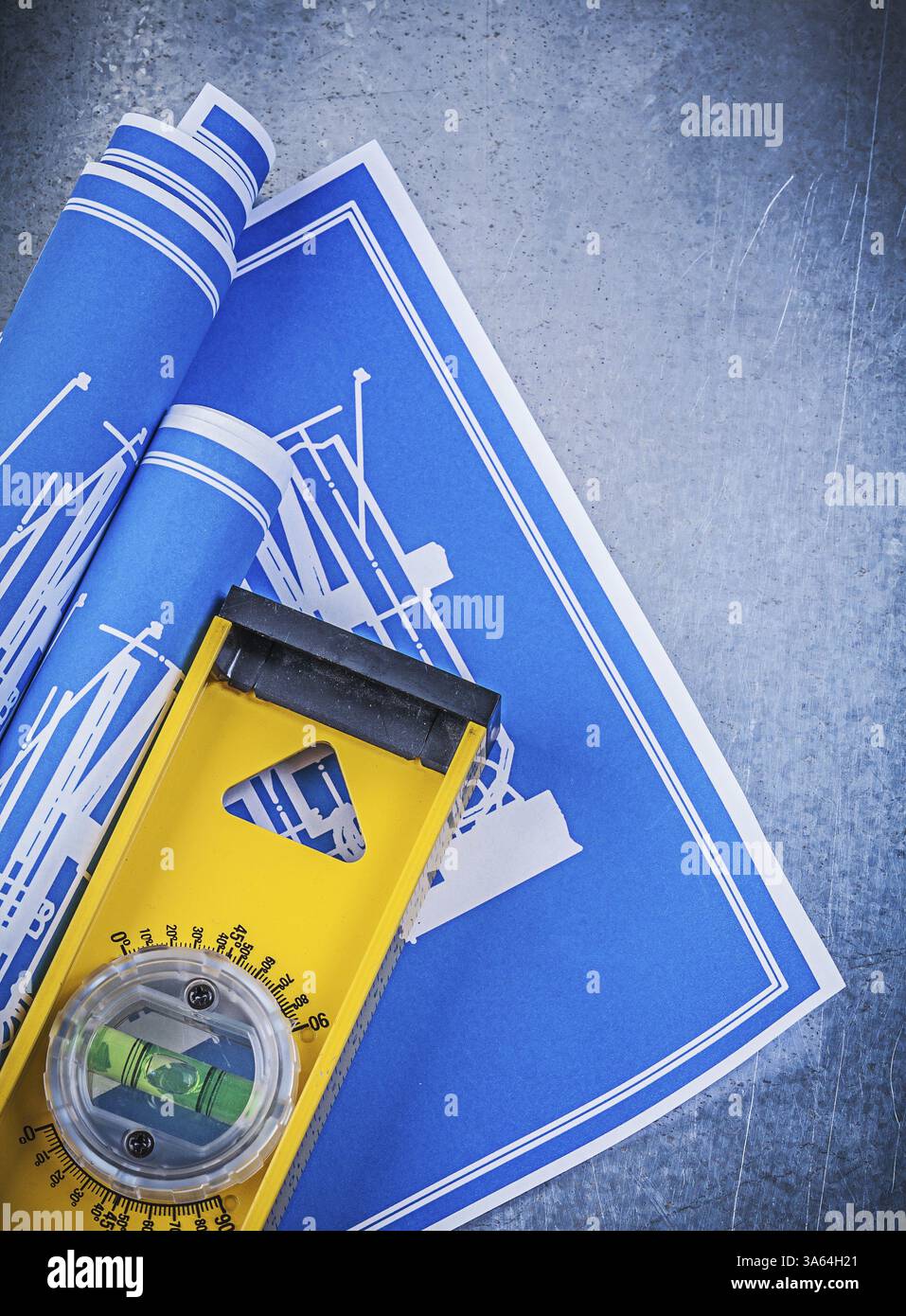 Blue blueprints yellow construction level on metallic background Stock ...