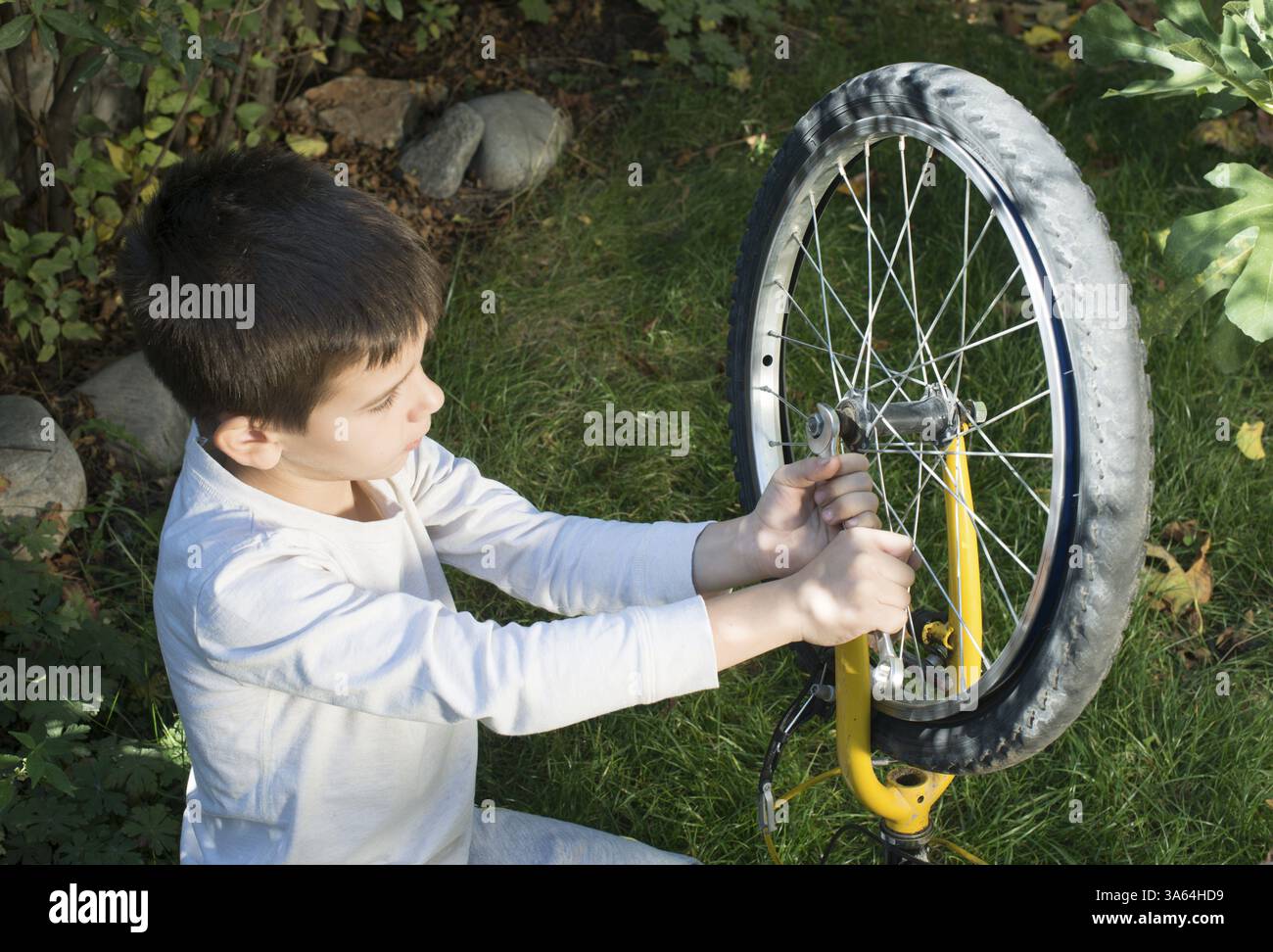 Child who fix bikes. Boy and bicycle Stock Photo - Alamy
