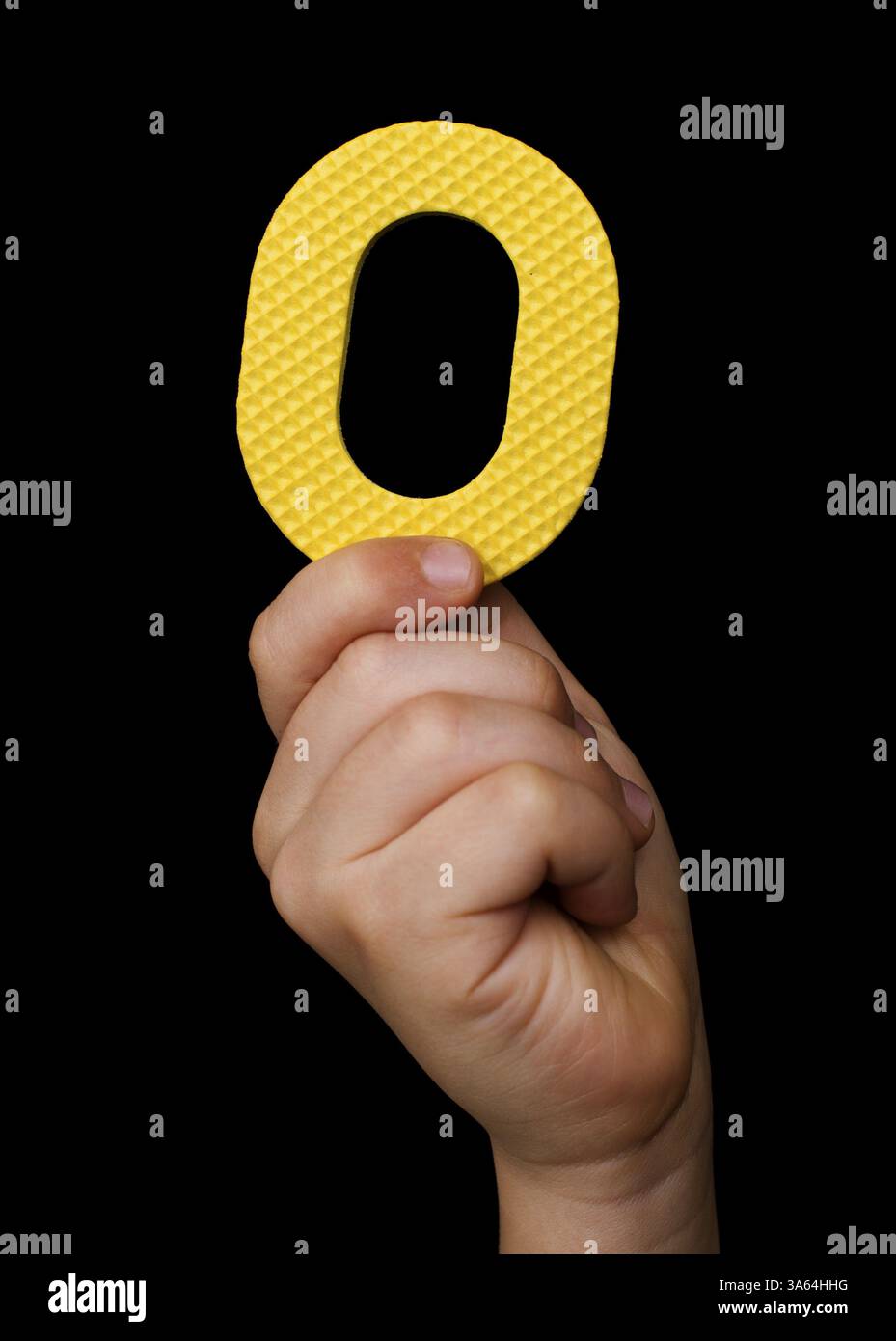 Children hand holding the number Zero. Black isolated yellow number ...