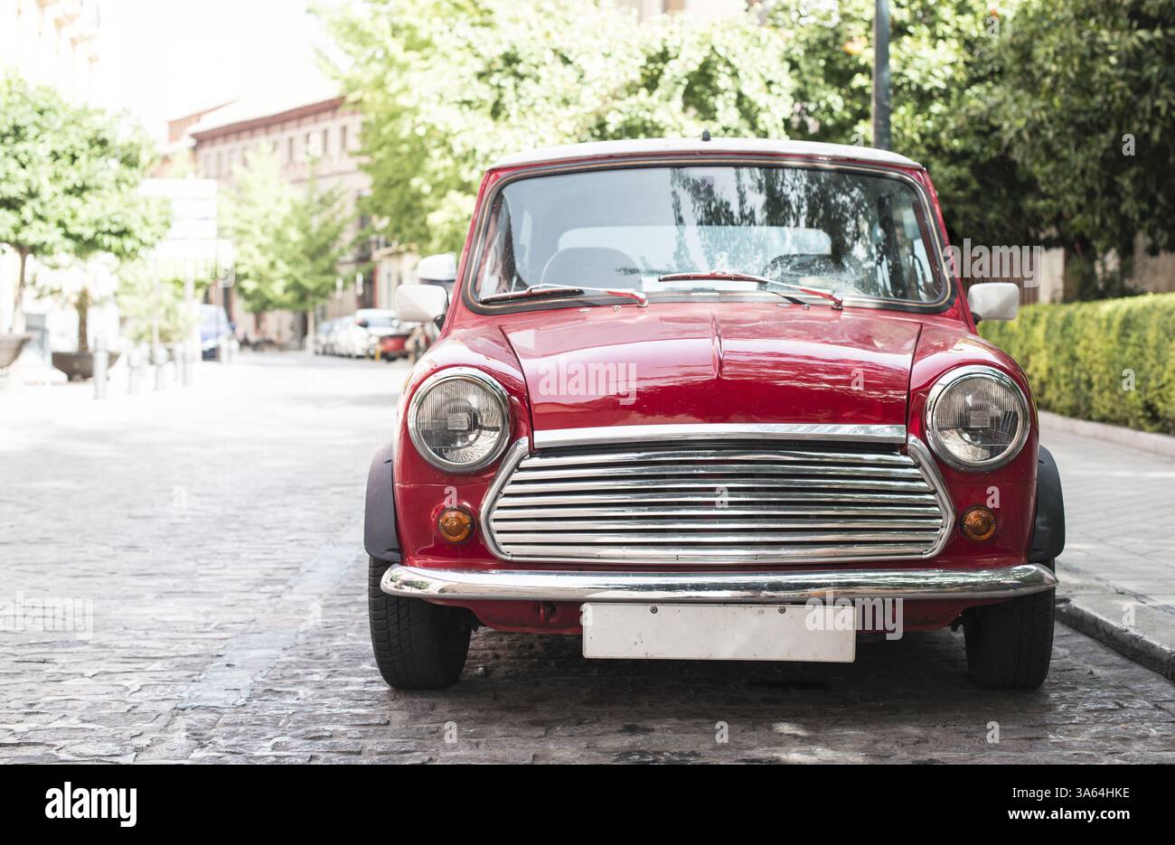 Vintage small red car on the street Stock Photo - Alamy