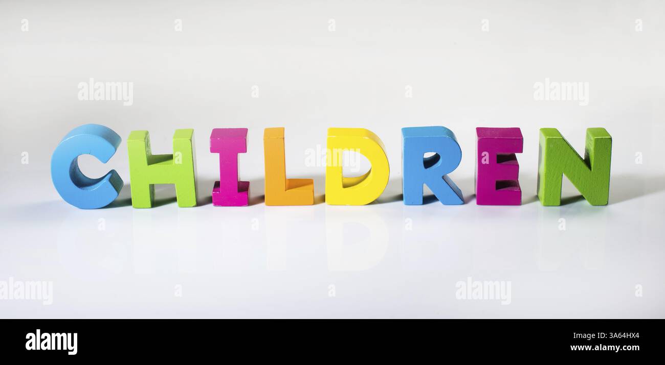 Multicolored text children made of wood. White background Stock Photo ...