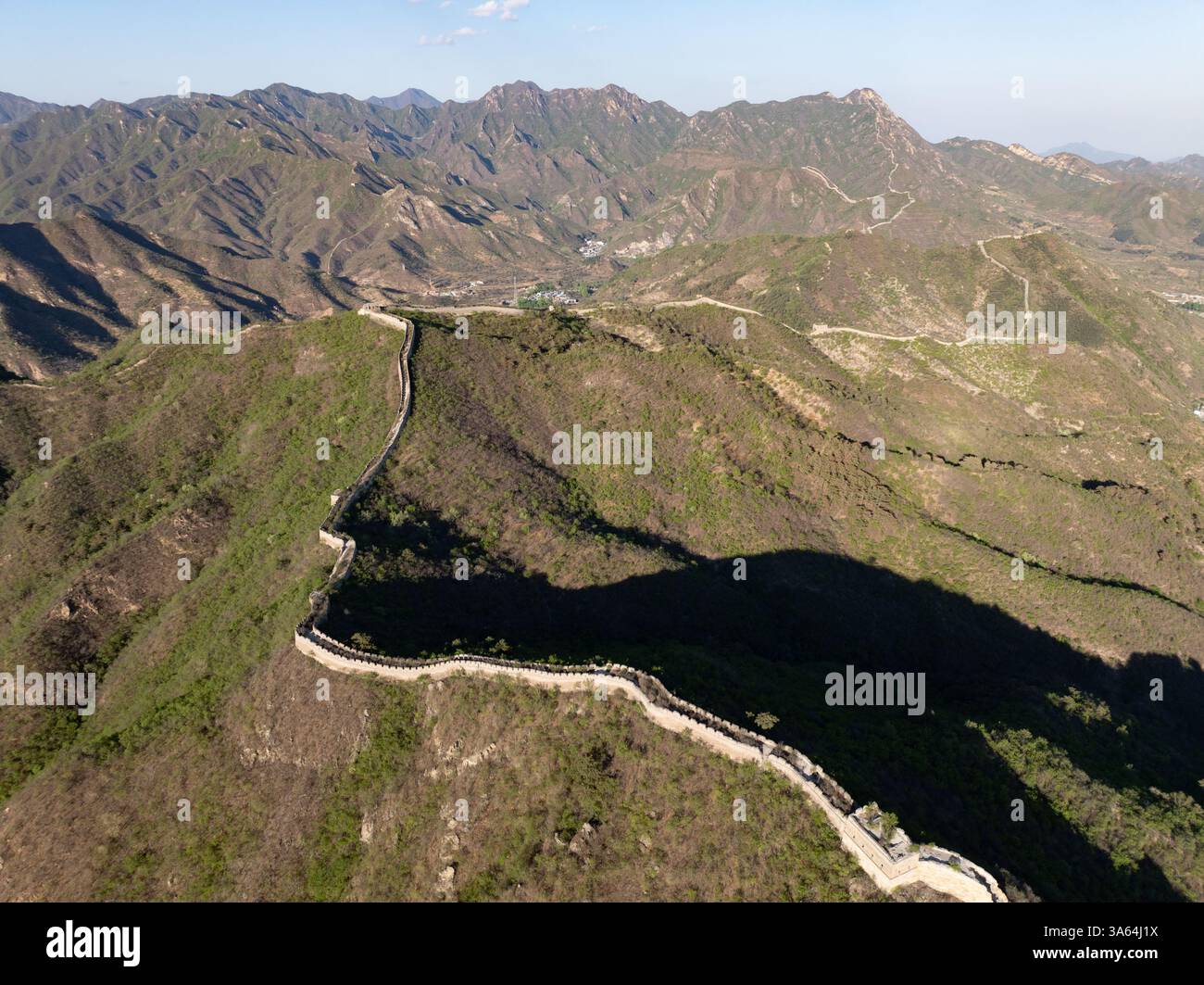A section of wild wall surround the preserved Great Wall section at ...