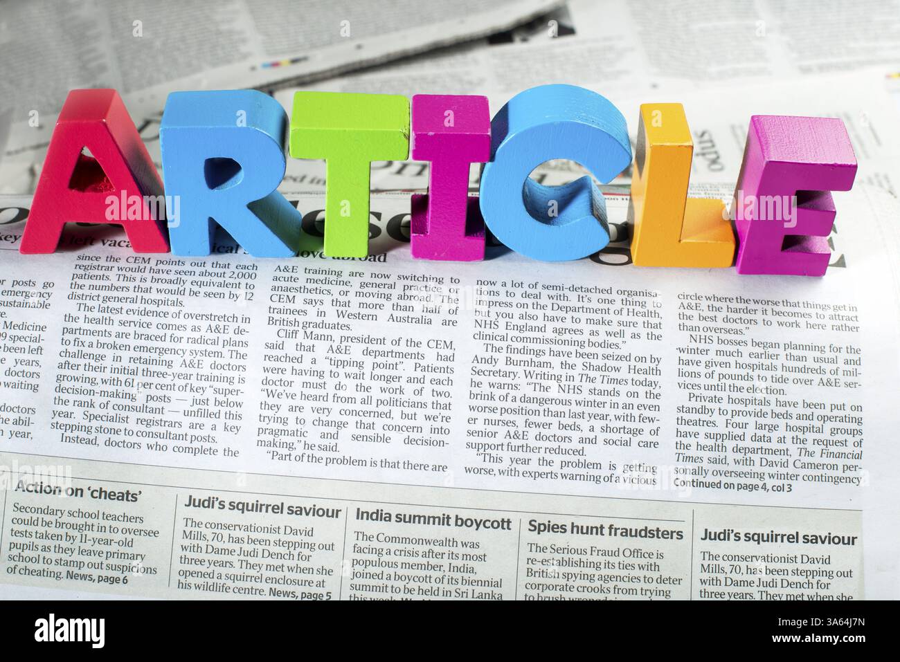 Word article on newspaper. Wooden letters Stock Photo - Alamy