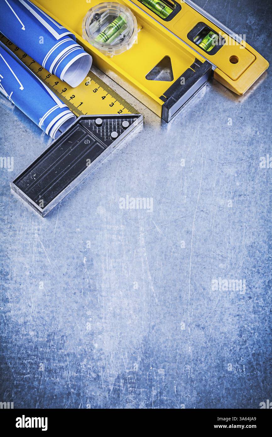Blue construction plans levels try square on metallic background Stock ...