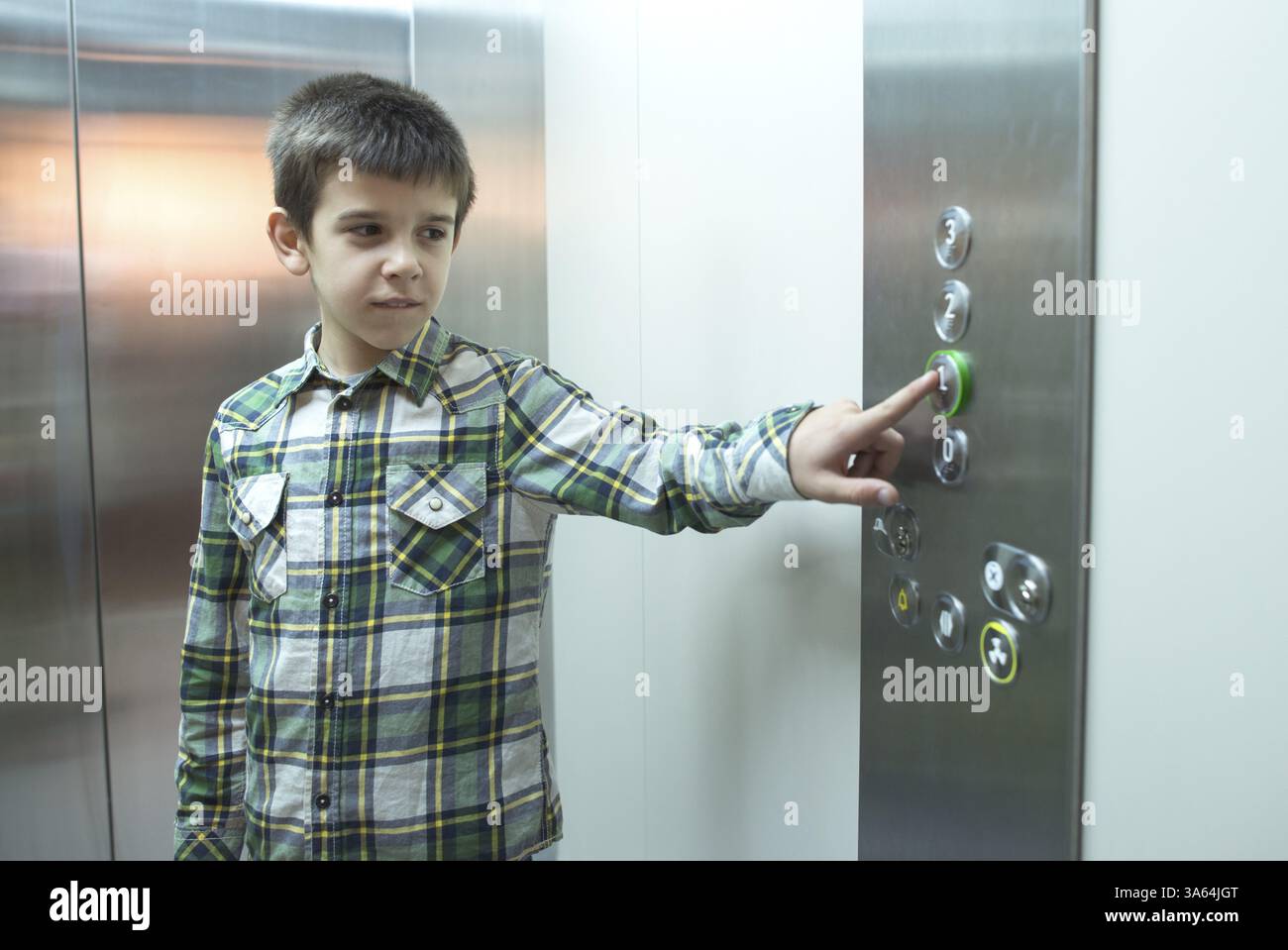Child pushed a button in an elevator Stock Photo - Alamy