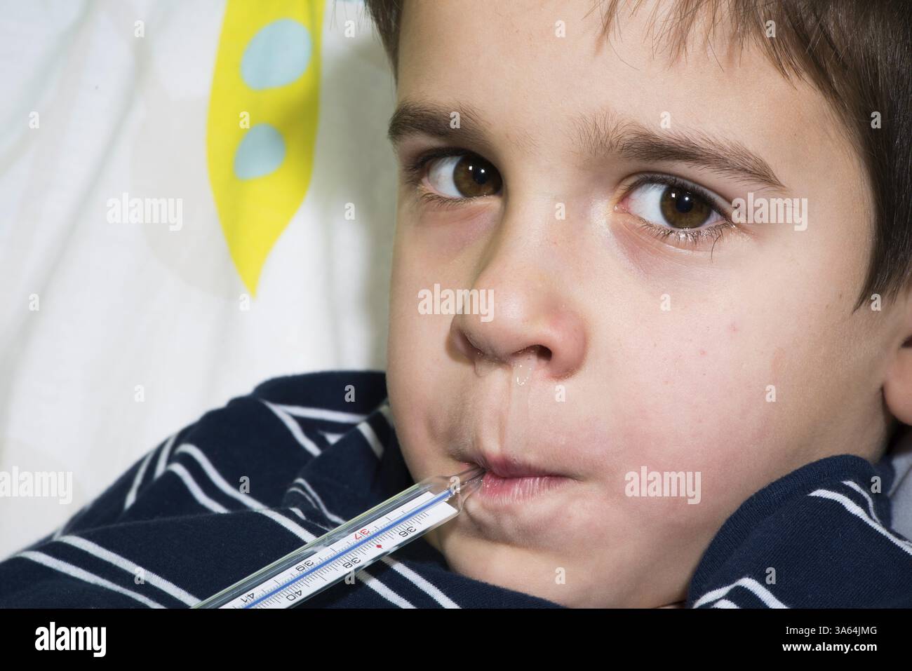 Sick child in bed. Measuring the temperature with a thermometer Stock ...