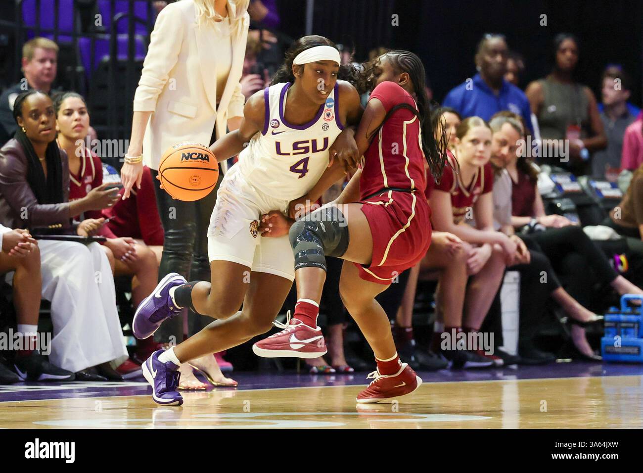 LSU Lady Tigers guard Flau'Jae Johnson (4) tries to drive past Florida State Seminoles guard Ta ...