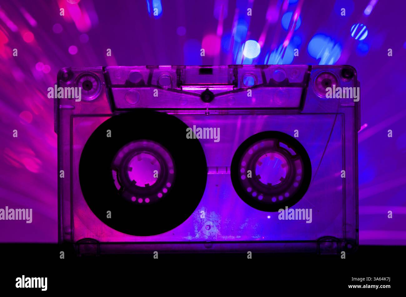 Transparent Cassette tape and blue pink color disco light background ...
