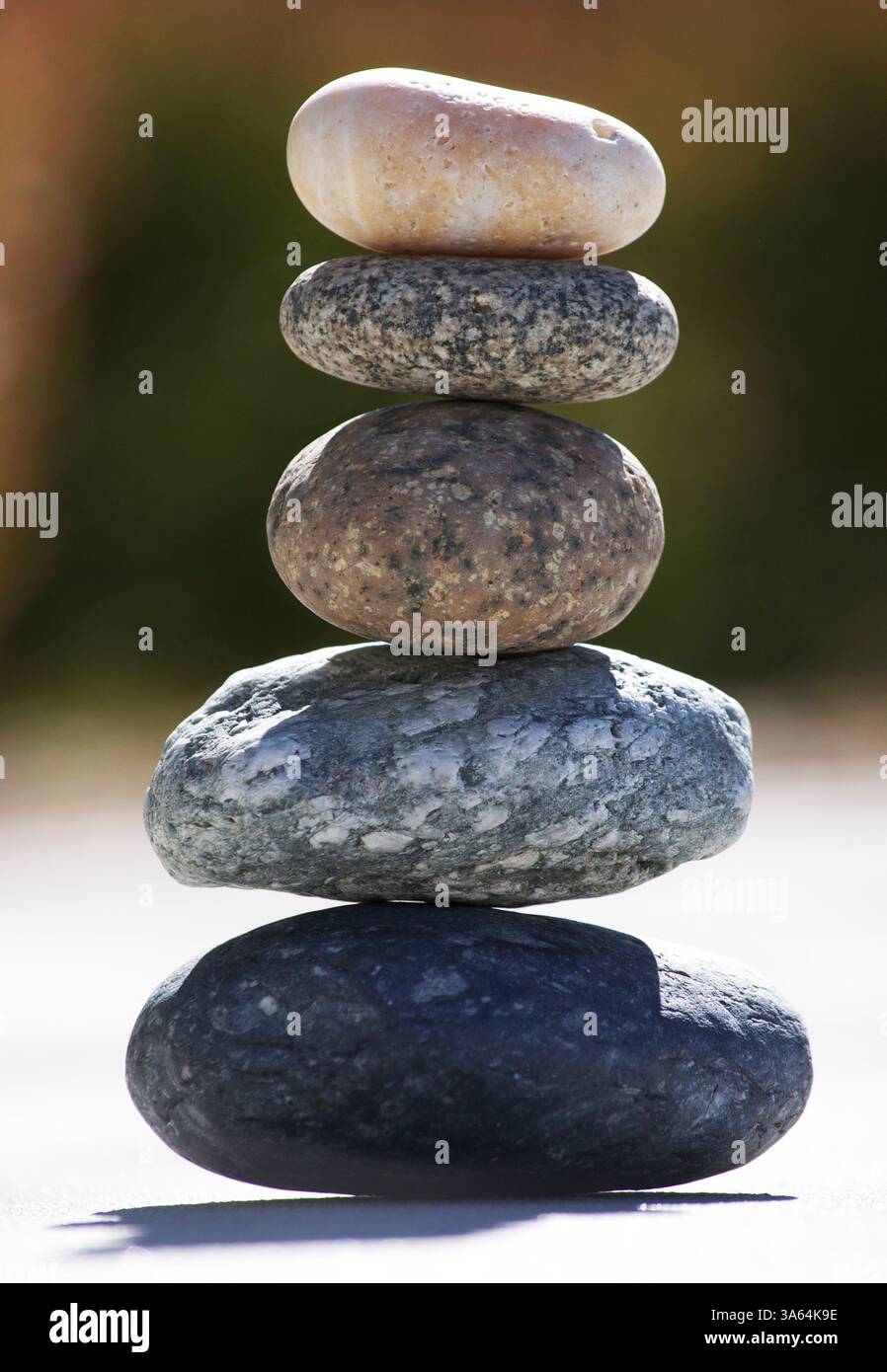 Vertical stack of river rocks against a neutral background Stock Photo ...