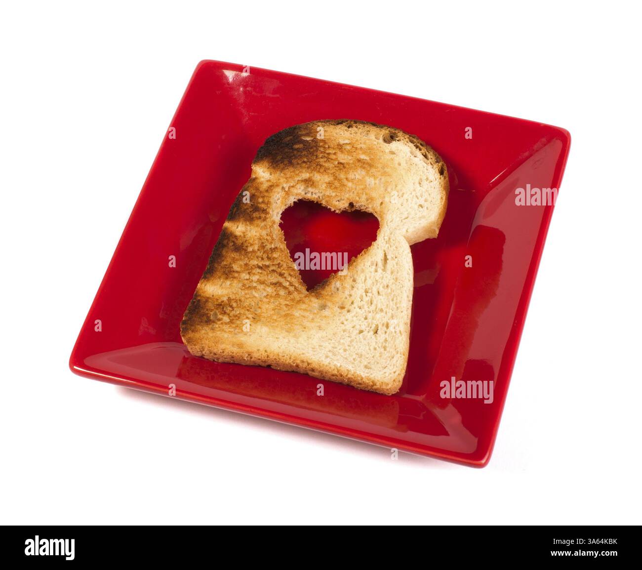 Toast with heart-shaped set in red plate Stock Photo - Alamy