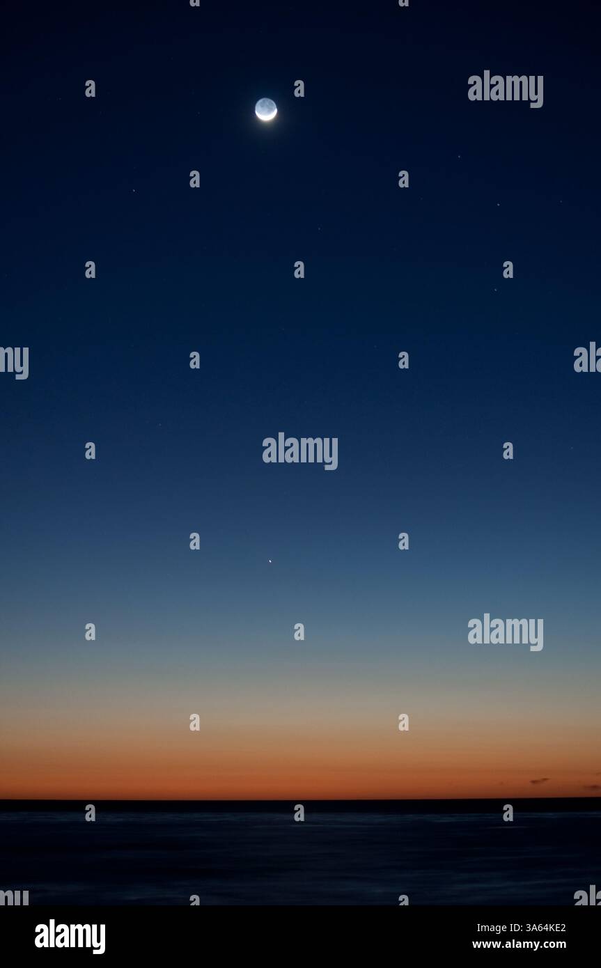 Crescent moon with detail in shadow during afterglow with Mercury ...