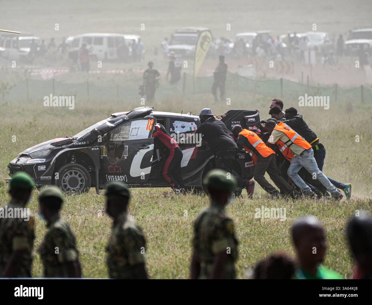 Naivasha. 23rd Mar, 2025. Staff members and contestants push a racing ...