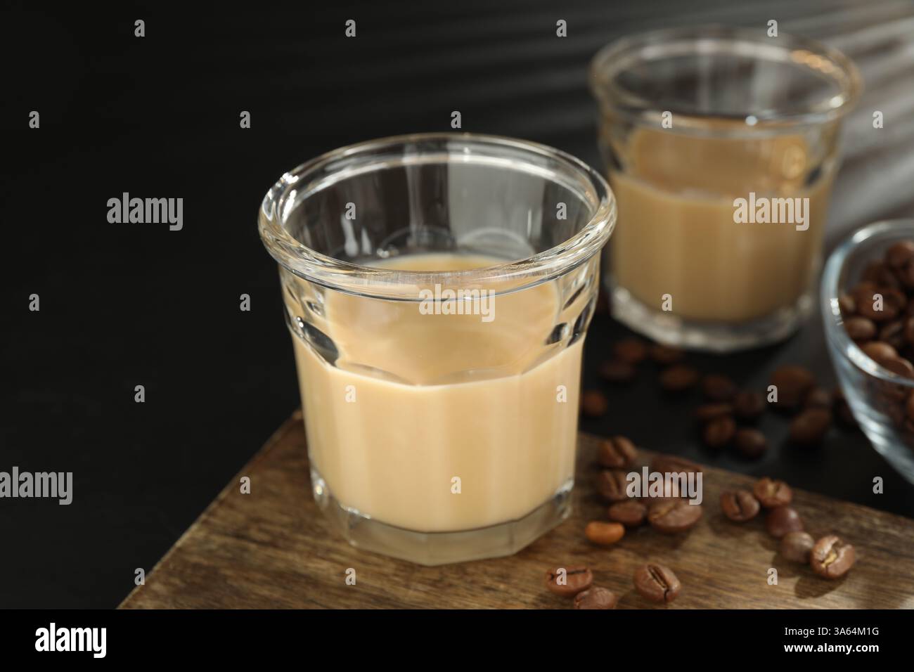 Coffee cream liqueur in glasses and beans on black table, closeup Stock ...