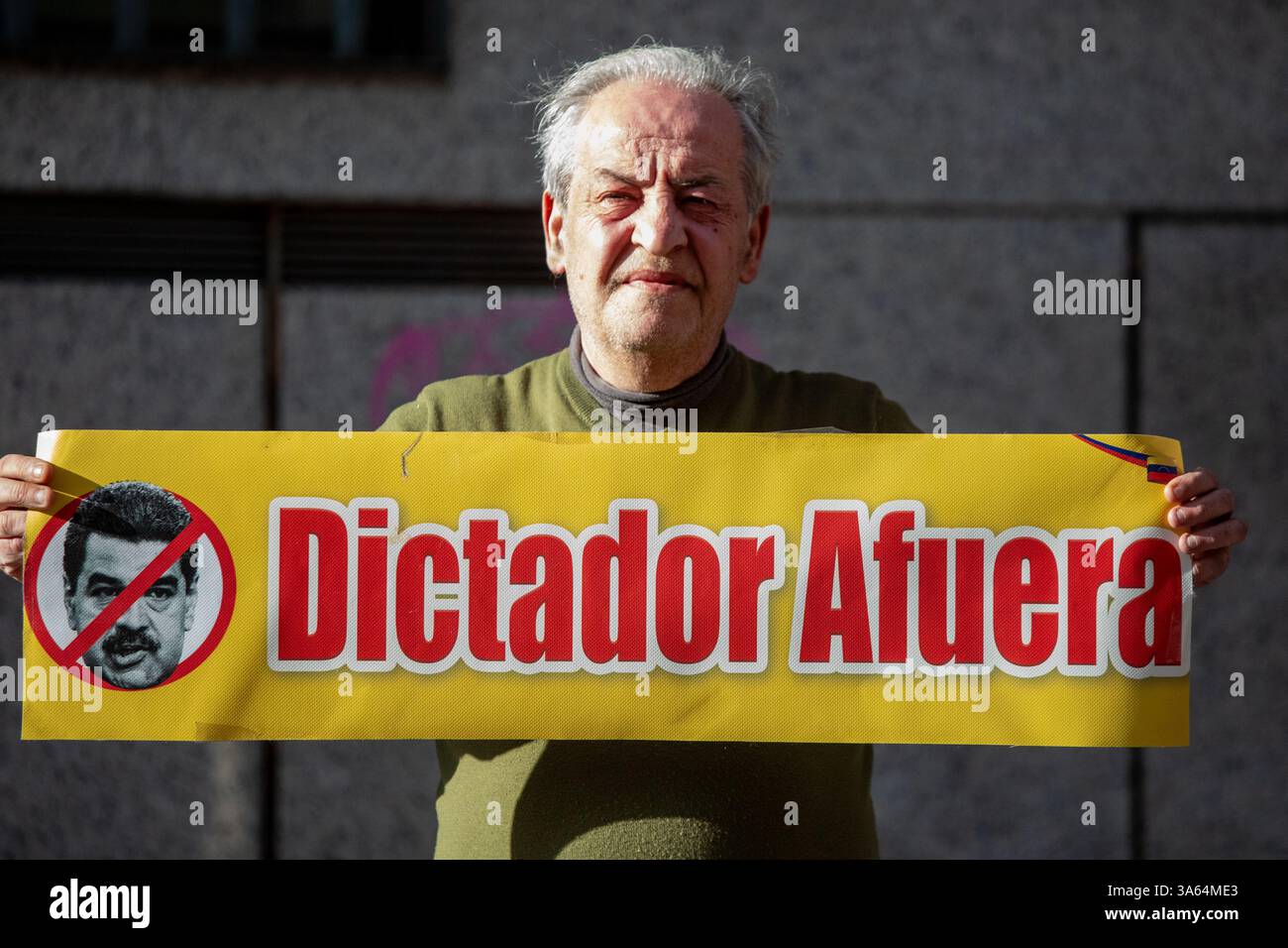 A member of the Venezuelan dissident movement holds a placard during ...
