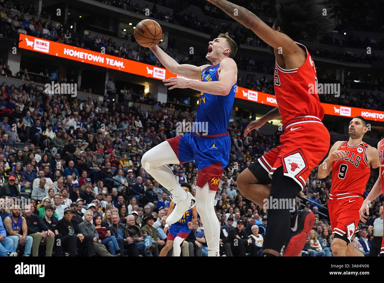 Denver Nuggets guard Christian Braun, left, drives to the basket as ...