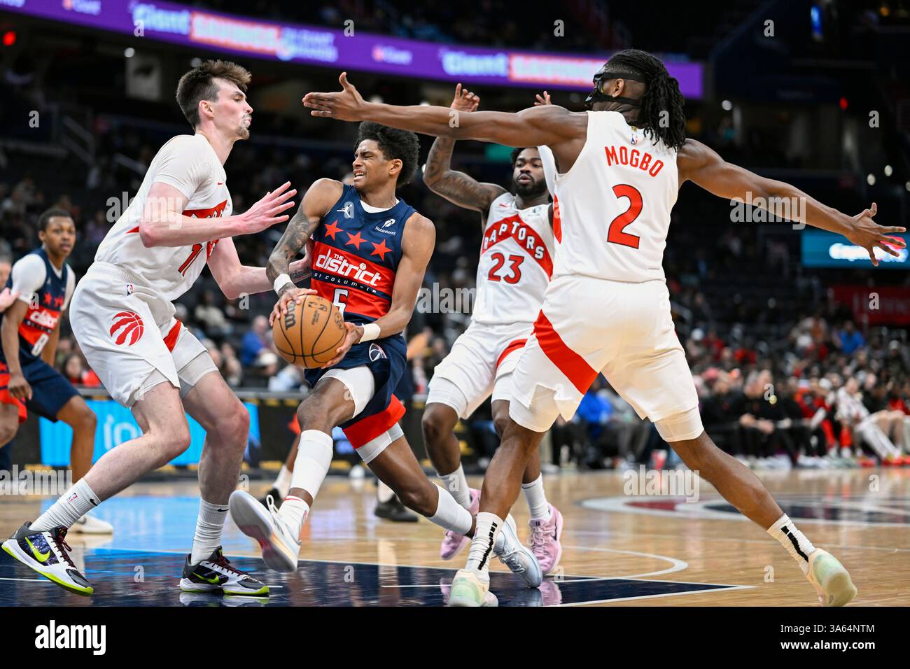 Washington Wizards guard AJ Johnson, center, fights his way through the ...