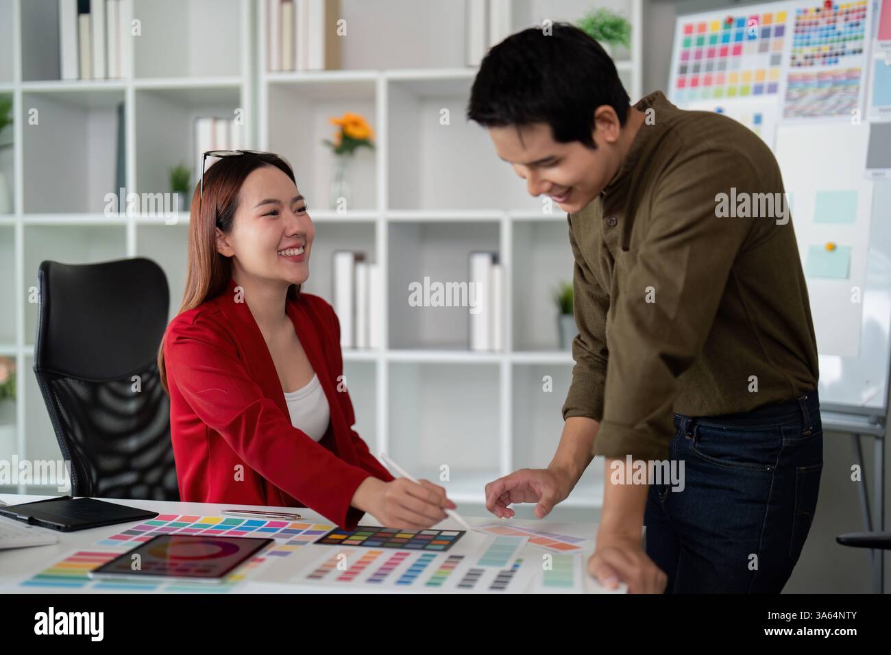 Color Selection and Teamwork. Colleagues collaborating on a visual ...