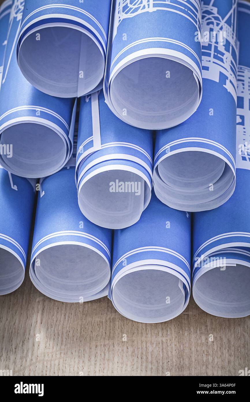 Composition of rolled engineering drawings on wooden board construction ...